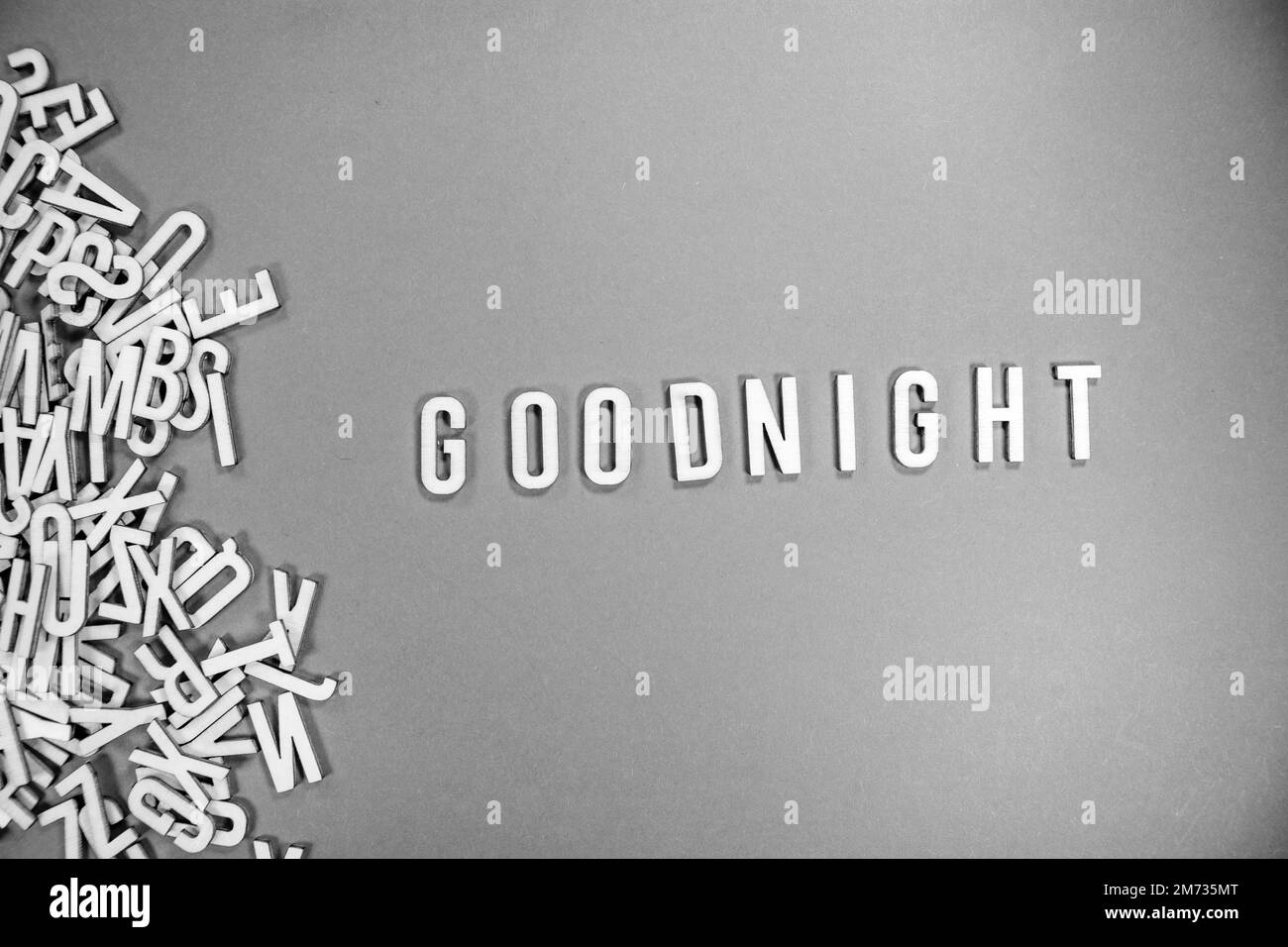 GOODNIGHT in wooden English language capital letters spilling from a ...