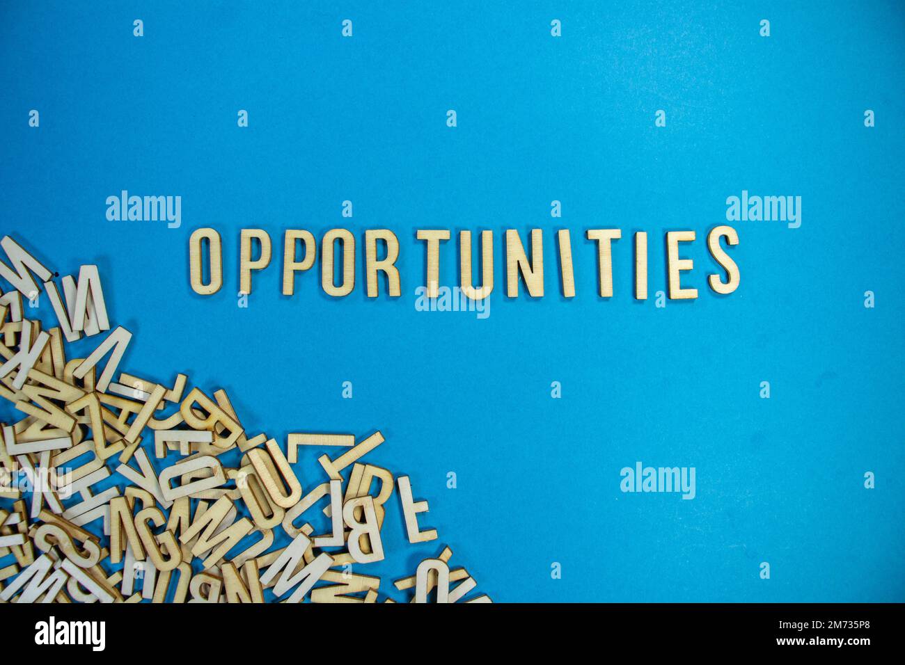 OPPORTUNITIES in wooden English words language capital letters spilling ...