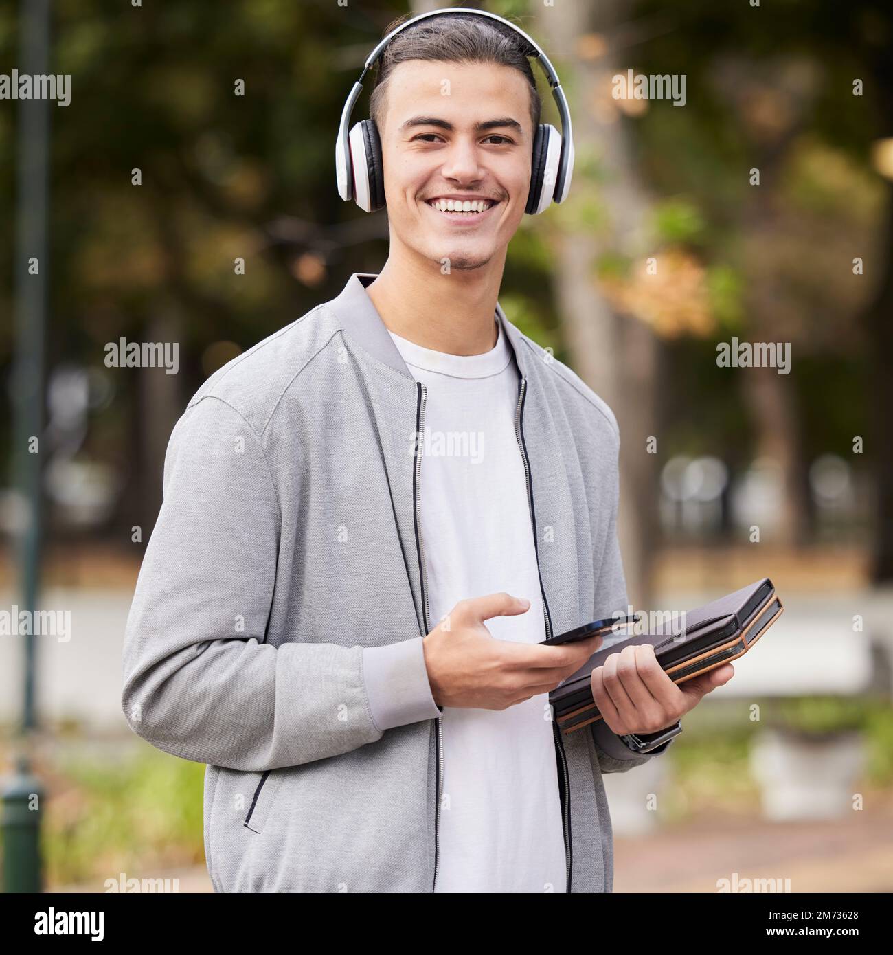 Smartphone, headphones and student portrait in park for study at ...