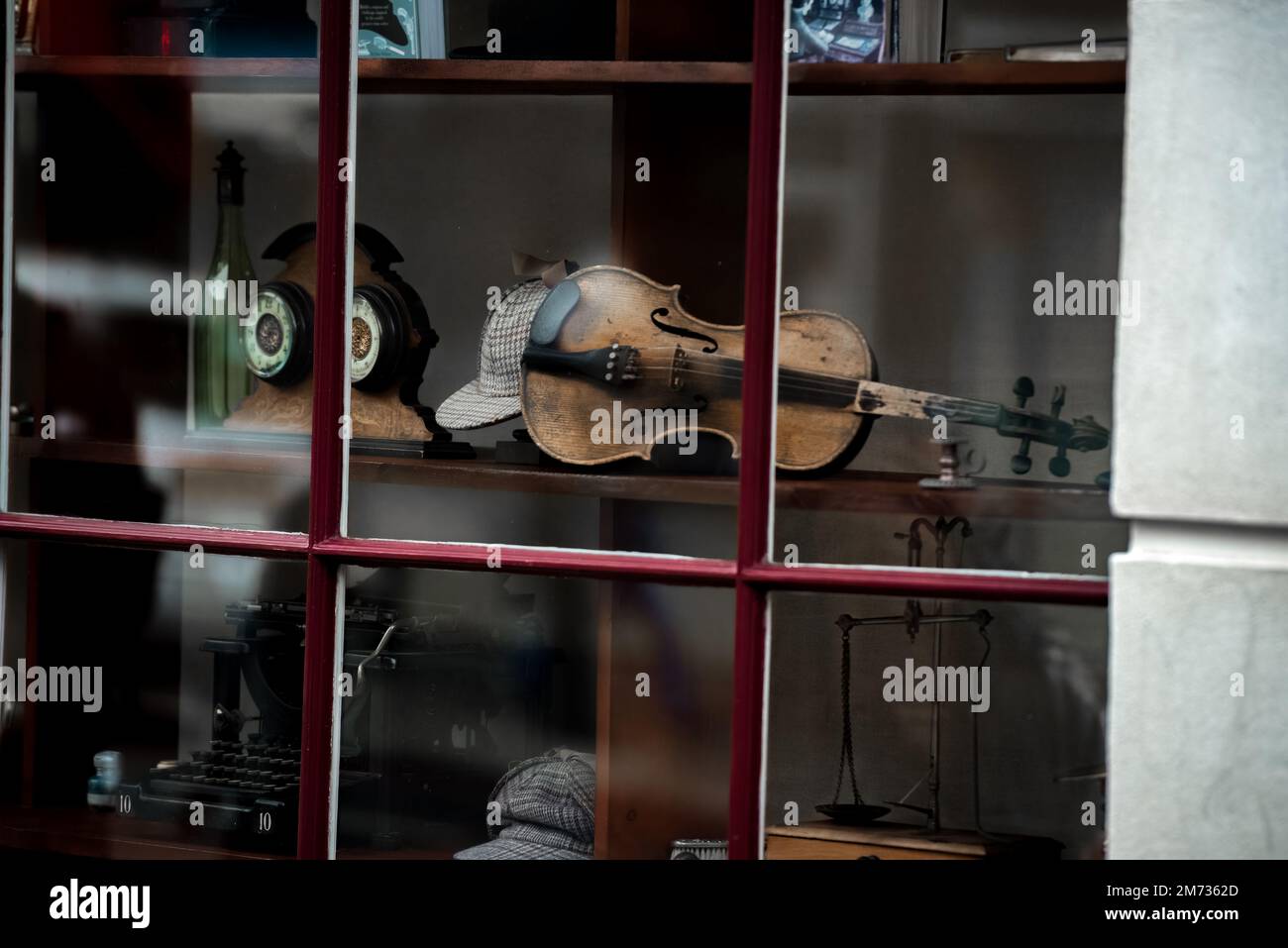 An old violin on a shelf from a window of a vintage store Stock Photo ...