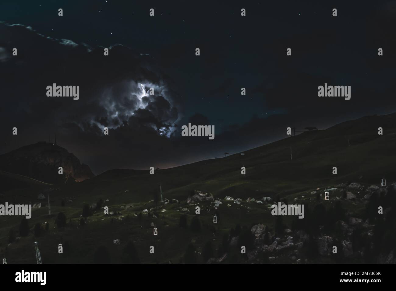 A dramatic view of a thunderstorm in the Dolomites, Italy, at night ...