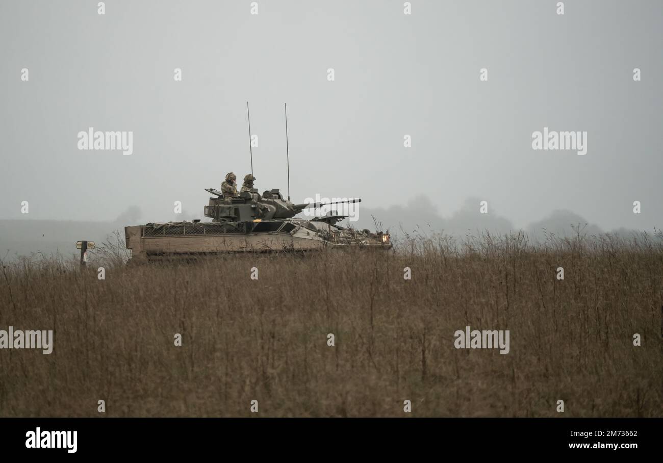 front quarter profile of commander and gunner directing a British army ...