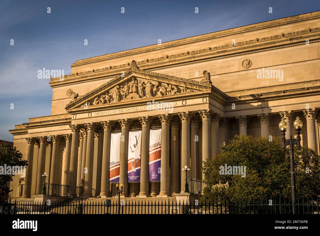 Sunlit neoclassical facade with Corinthian columns of the National ...