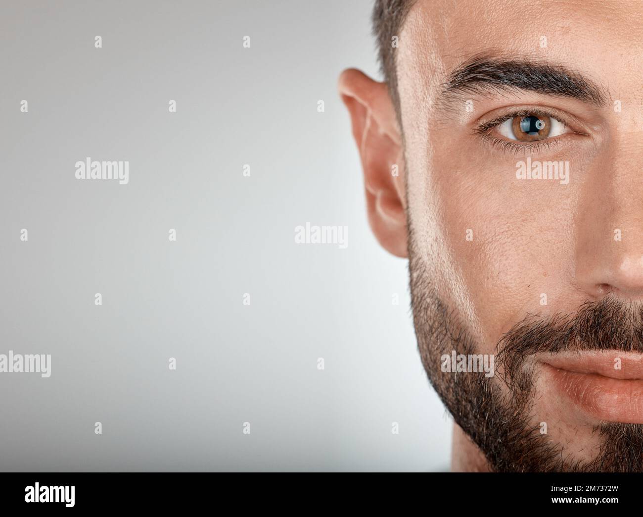 Face, beauty and eye of a man with clean, glow and healthy skin on a ...