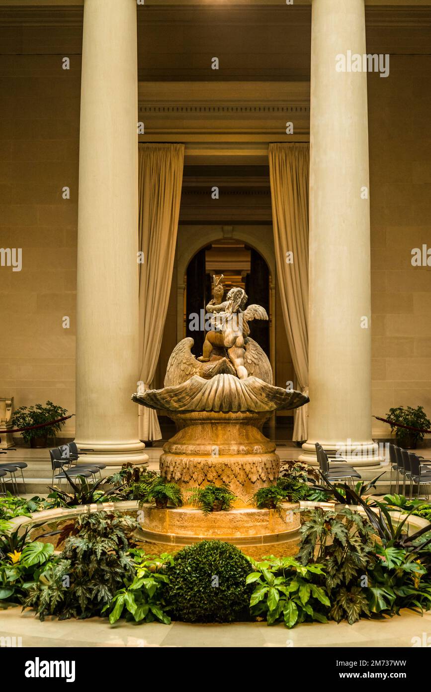 Water fountain surrounded with plants in the Neoclassical interior of ...