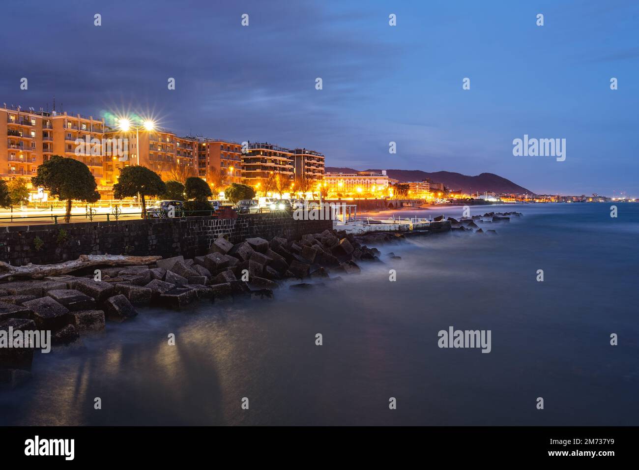 The seaside landscape and the buildings of Salerno, Italy at sunset ...