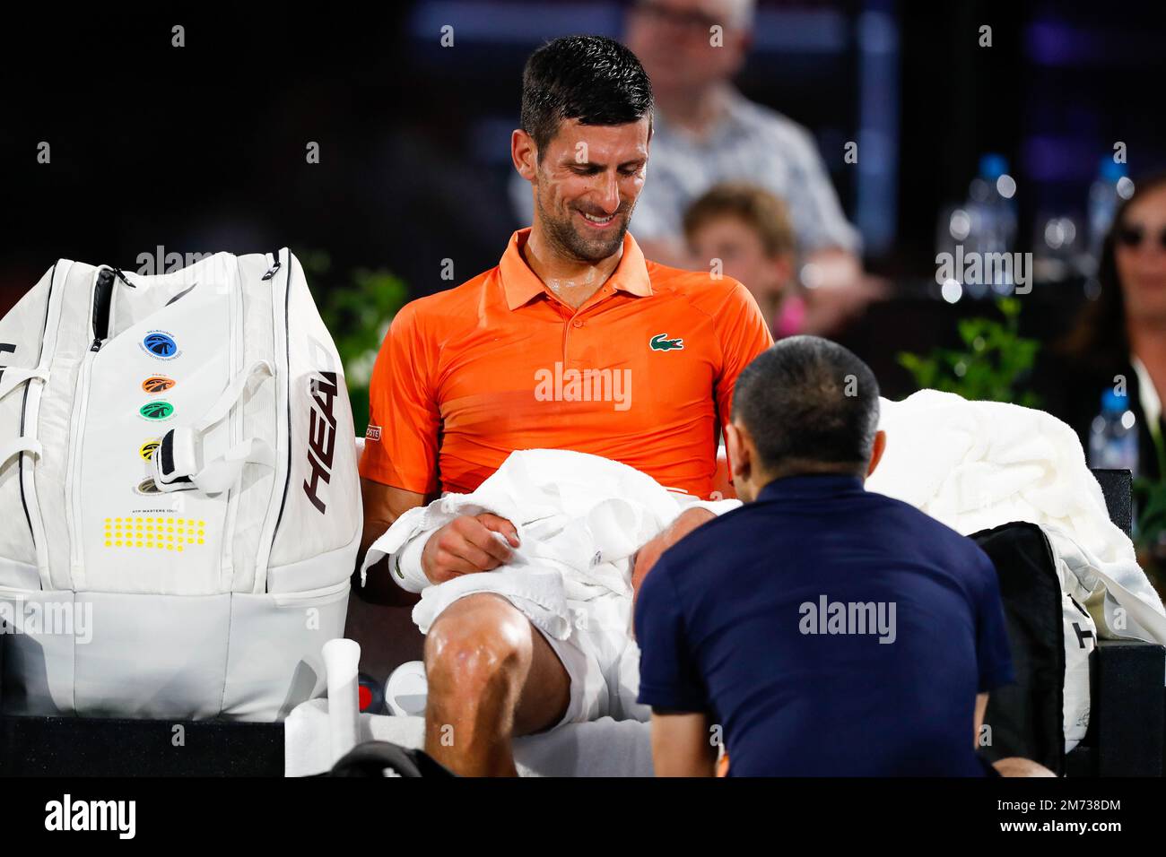 Novak Djokovic of Serbia with a physio after injuring his hamstring in ...