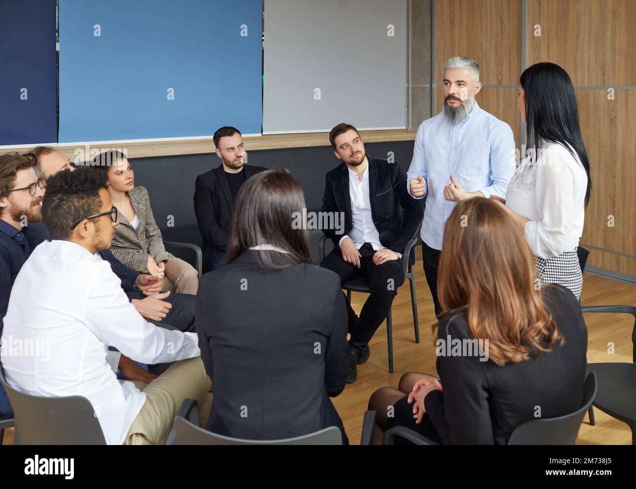 Professional male leader and coach who training staff speaks at meeting ...