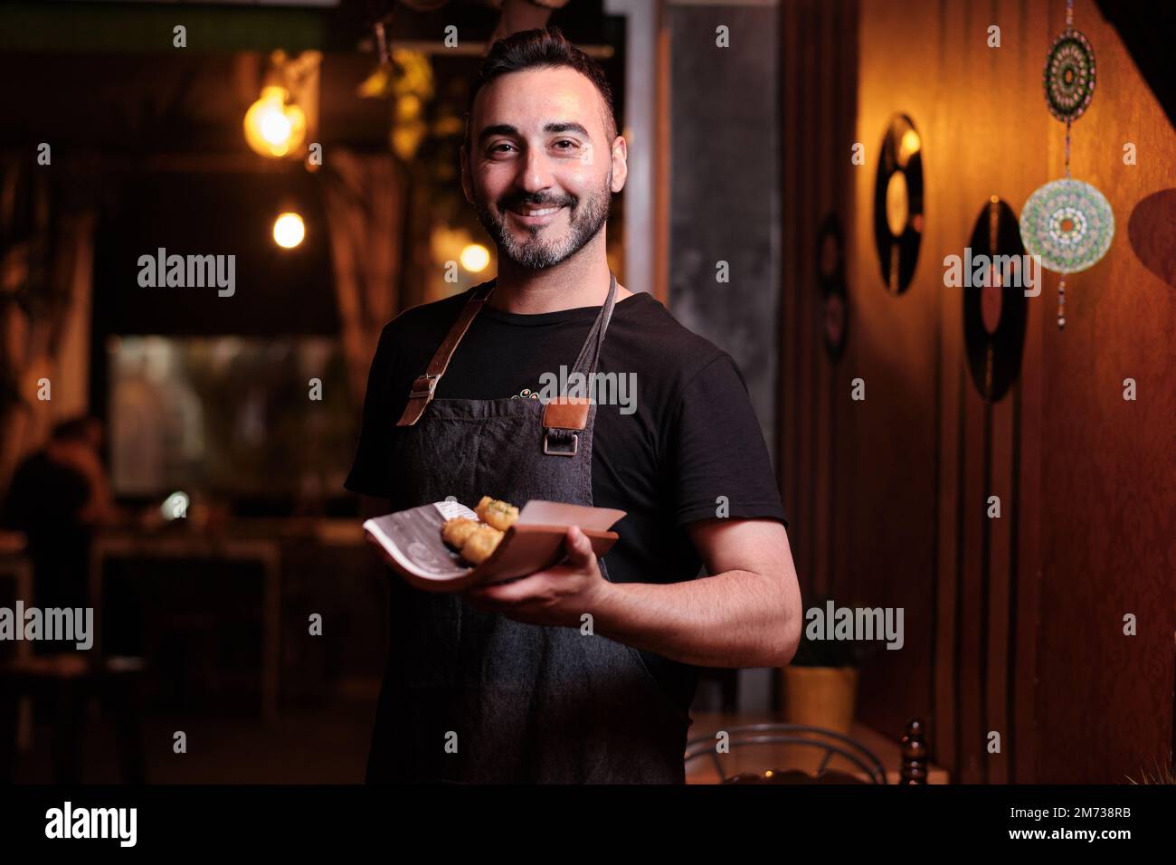 Restaurant employee in apron smiling hi-res stock photography and ...