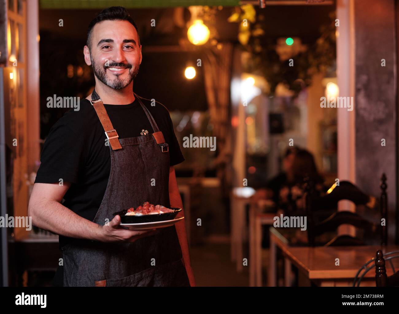 Restaurant employee in apron smiling hi-res stock photography and ...