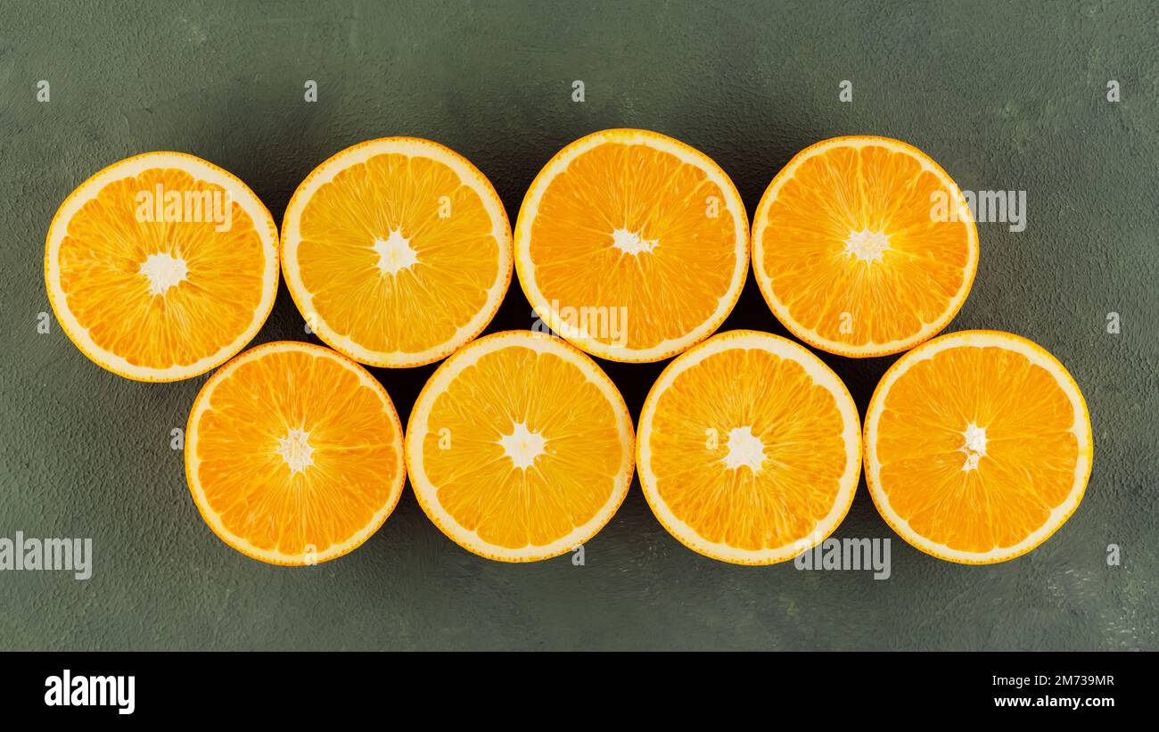 Halves of juicy oranges on a green background. Half cut oranges for ...