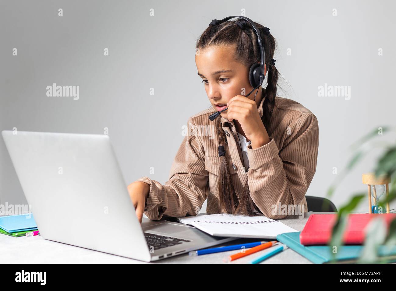 E-Learning. Shocked Little Schoolgirl Looking At Laptop Wearing ...