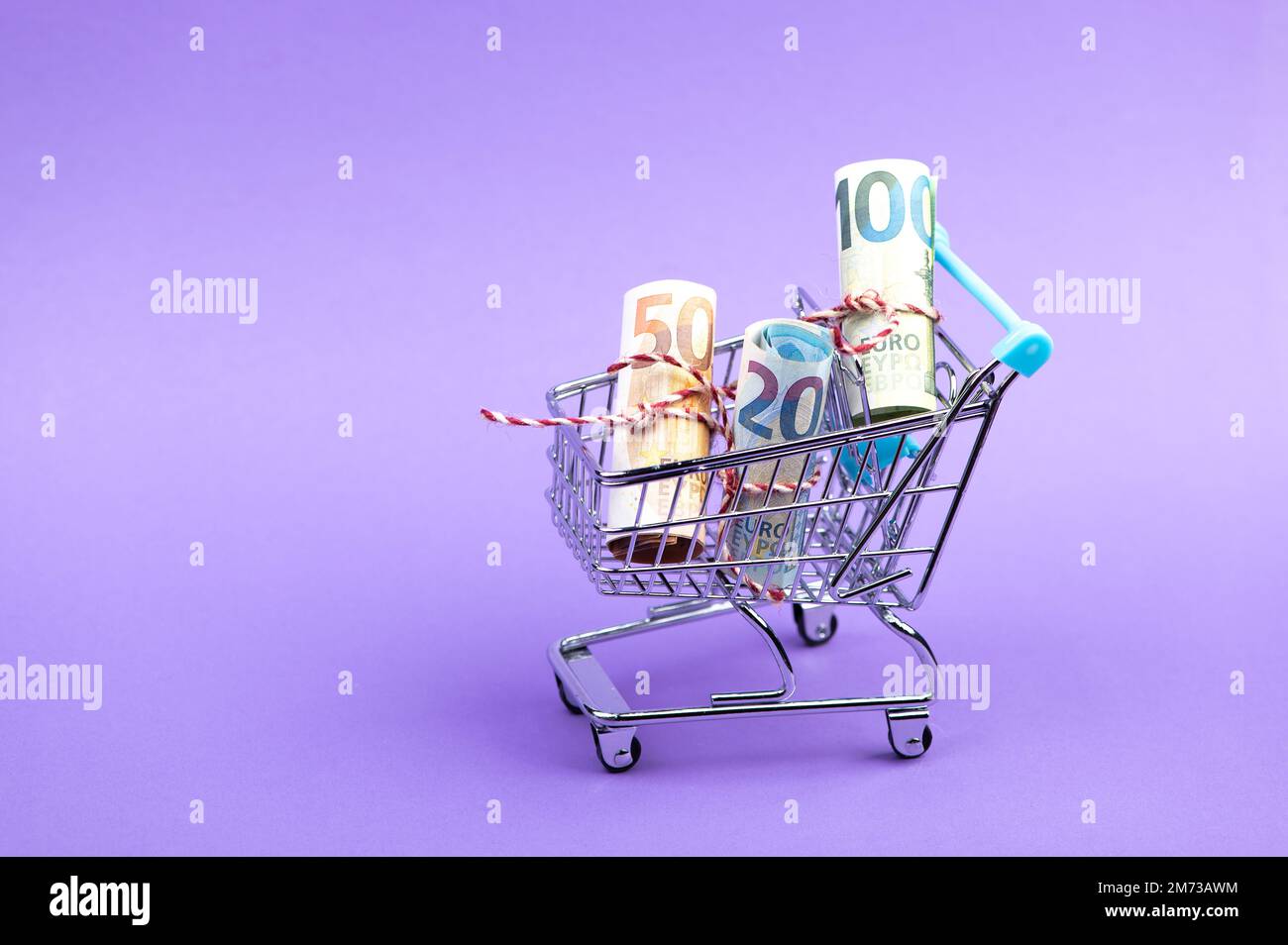 Shopping cart full of roll euro banknotes Stock Photo - Alamy
