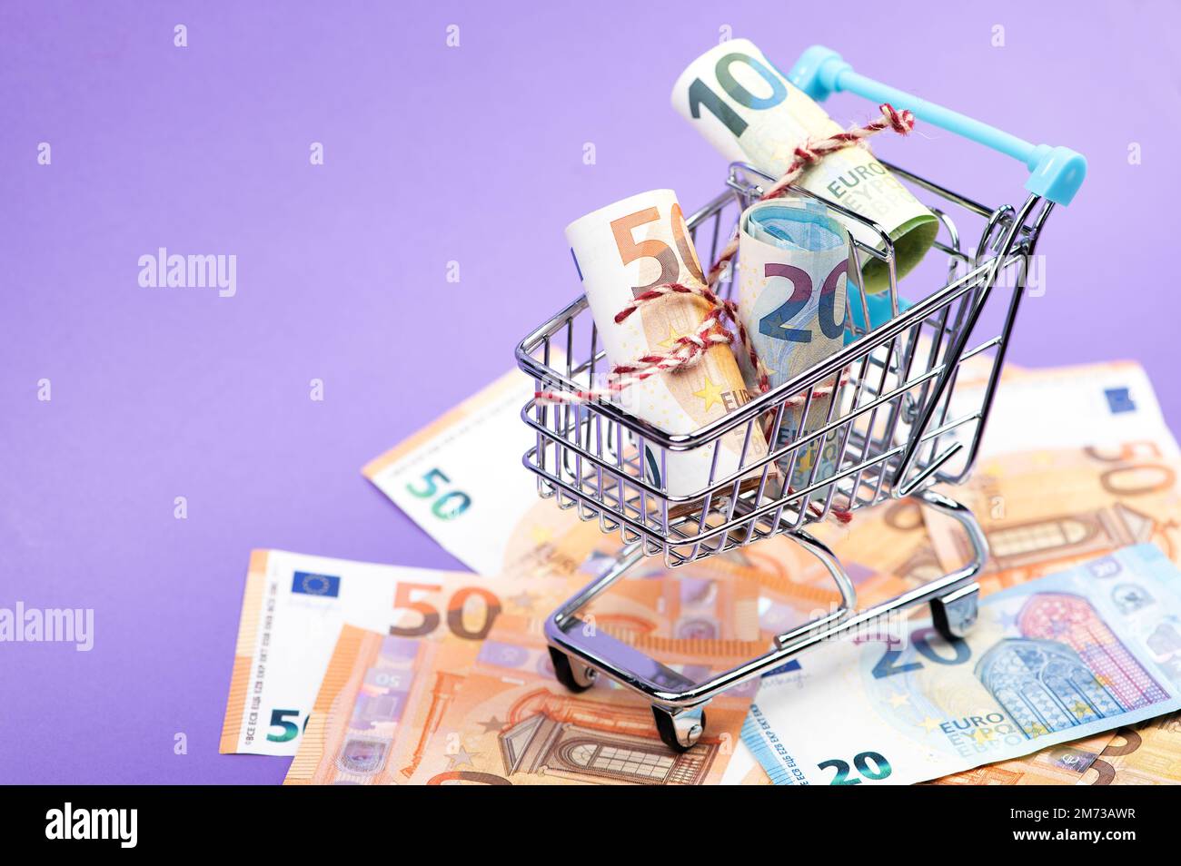 Shopping cart full of roll euro banknotes Stock Photo - Alamy