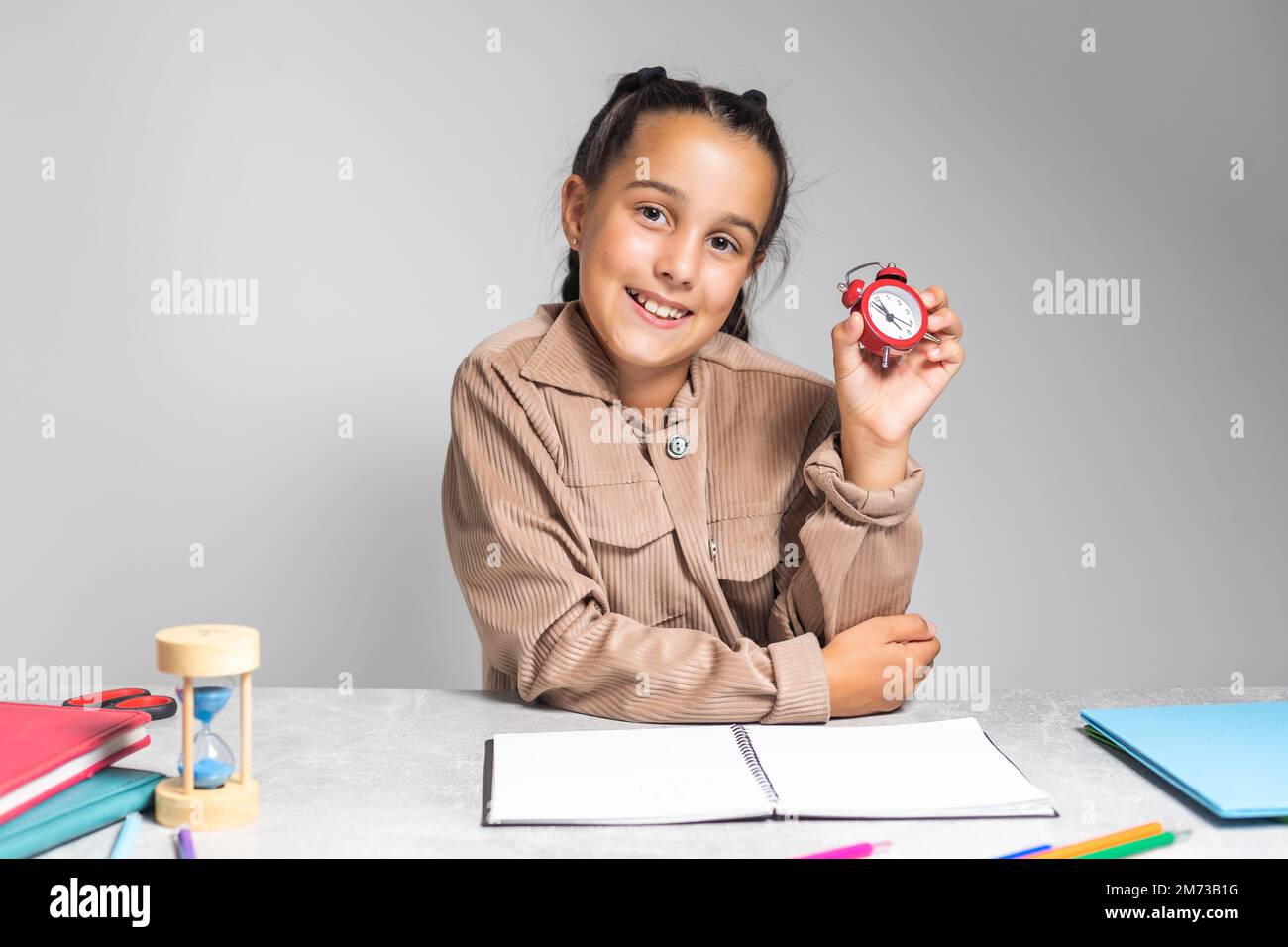 little girl of preschool age studying with clock Stock Photo - Alamy