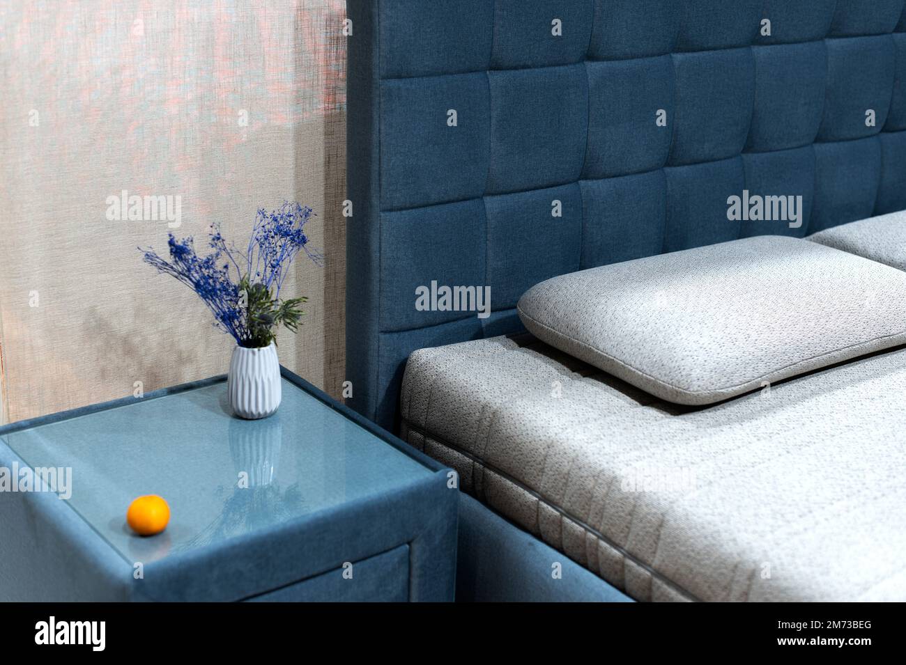 Gray pillow on blue bed decoration in bedroom interior Stock Photo - Alamy