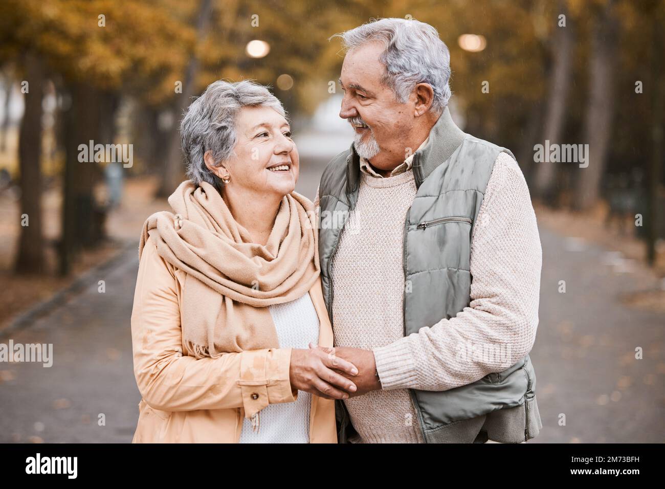 Senior couple, love and hug while walking outdoor for exercise ...