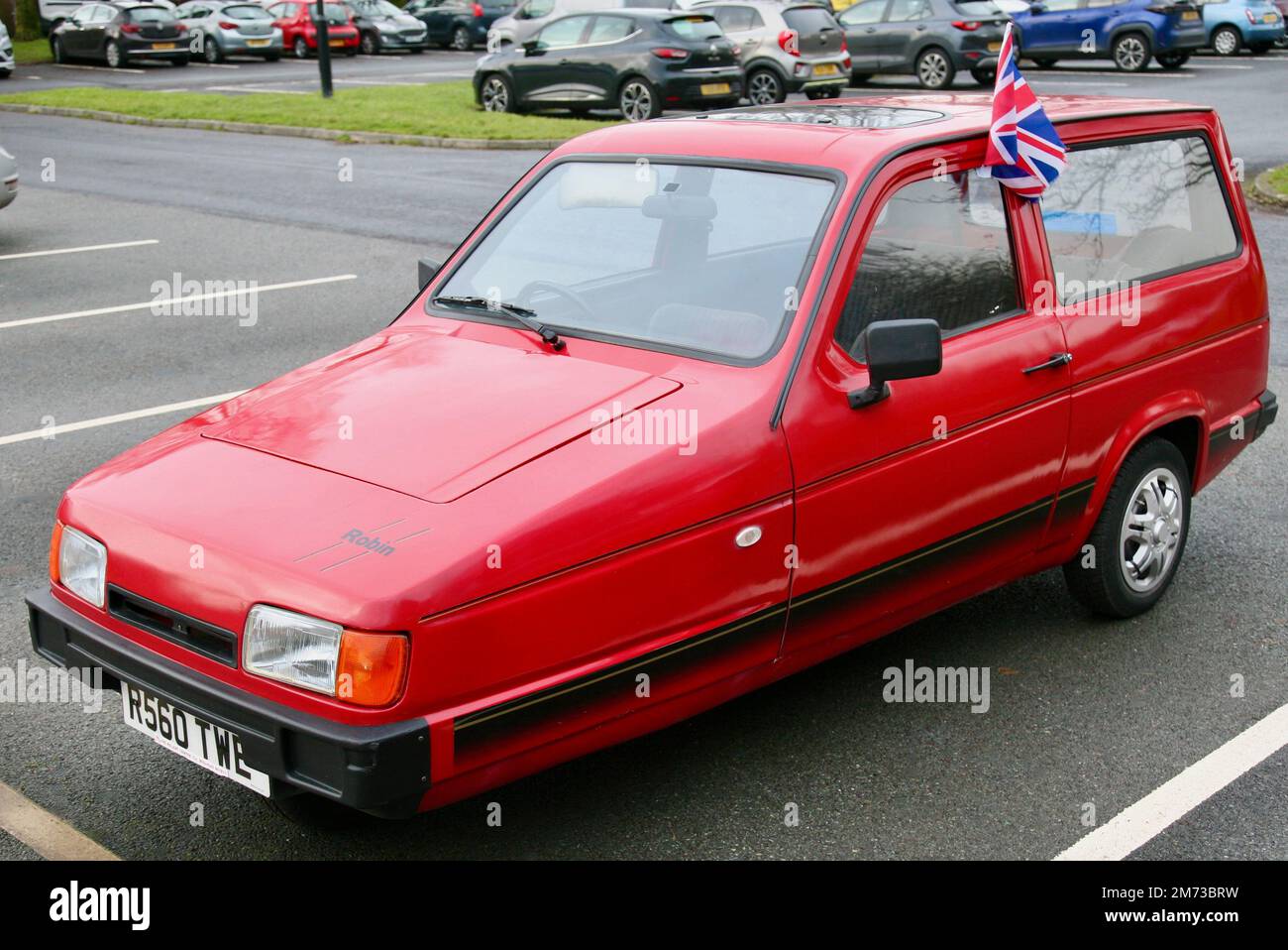 A close up view of a classic red Reliant Robin three wheeler motor car ...
