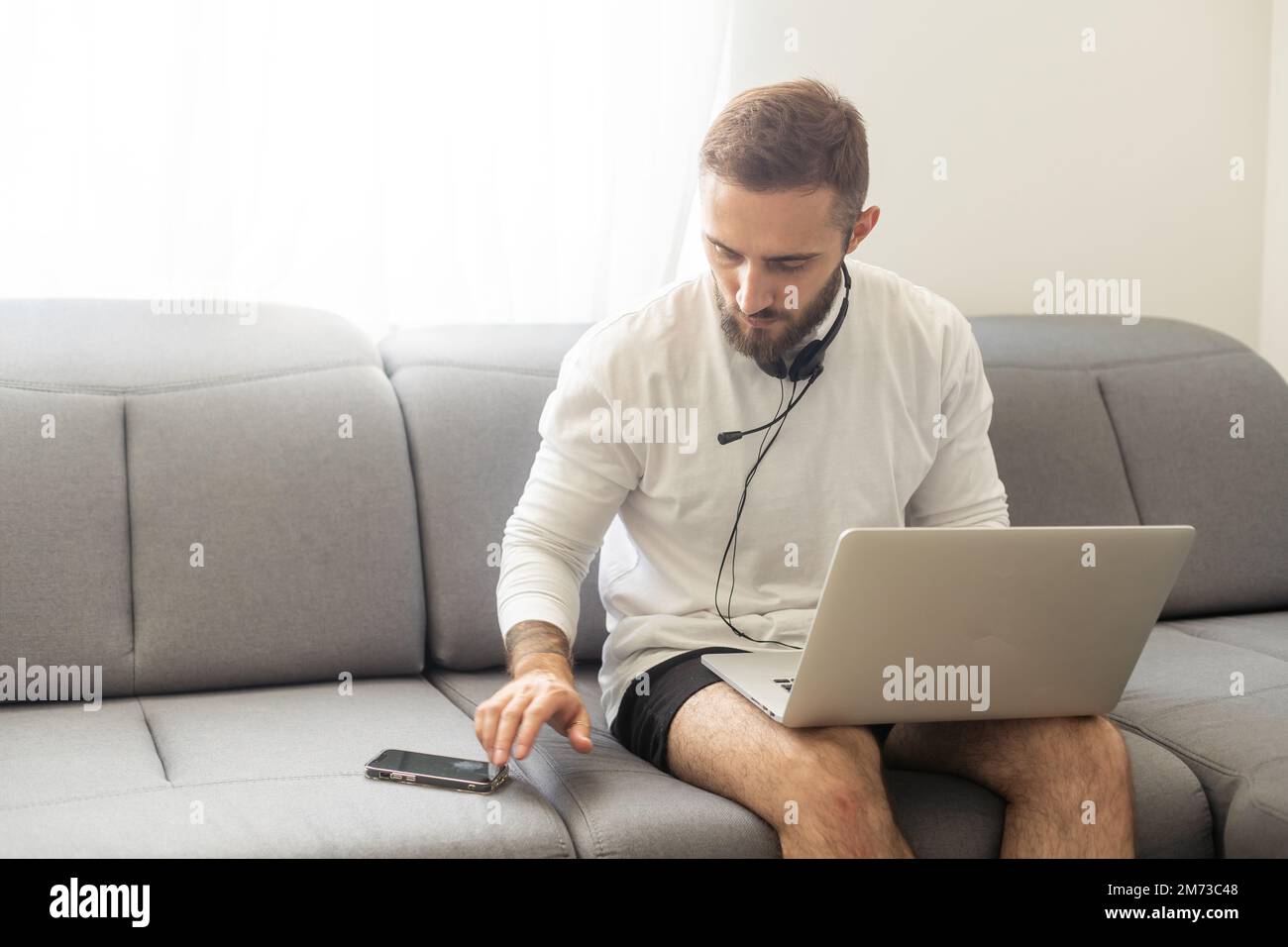 Young man freelancer using laptop studying online working from home ...
