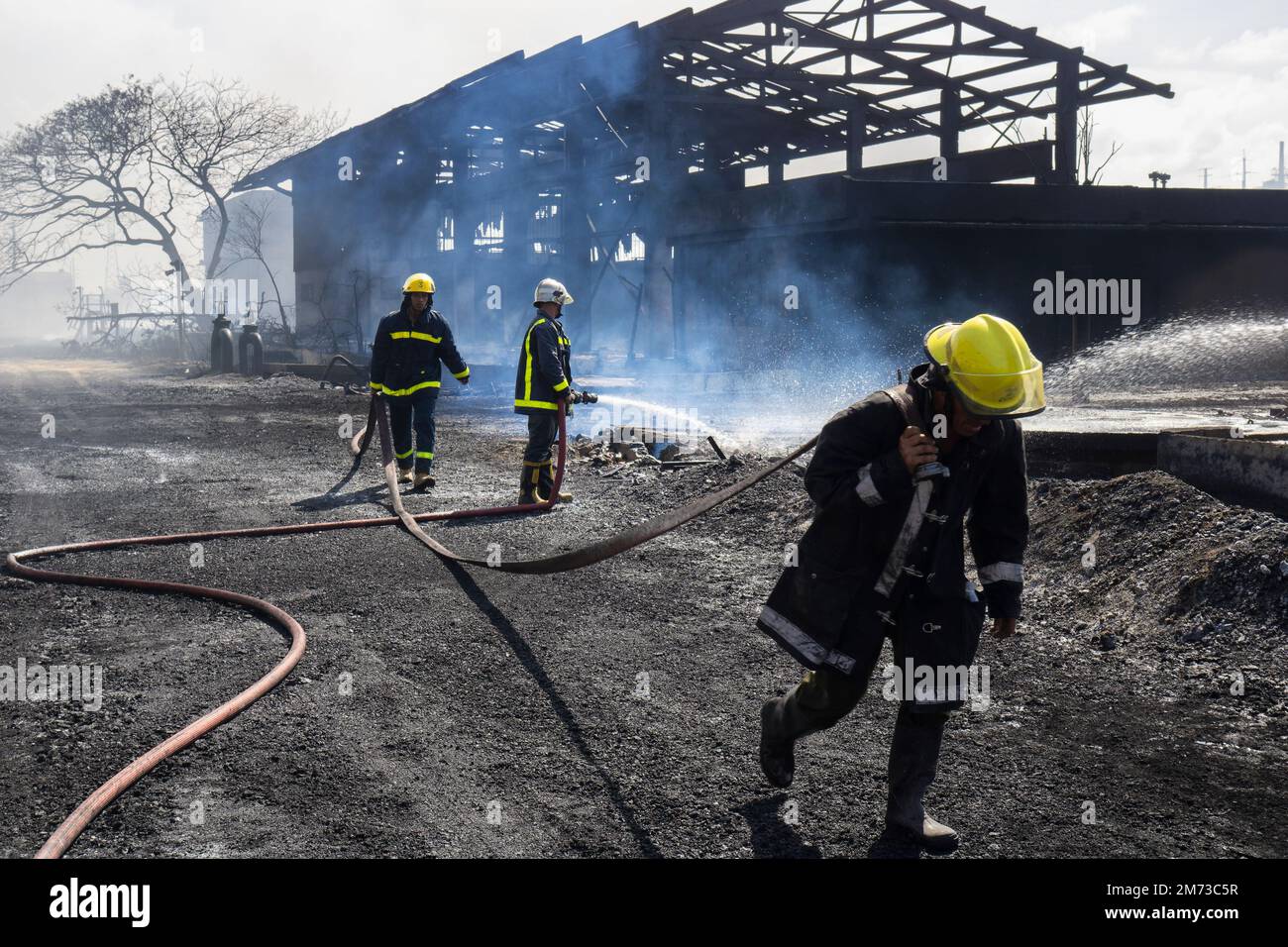 The firefighters facing a large-scale fire at the supertanker base in ...