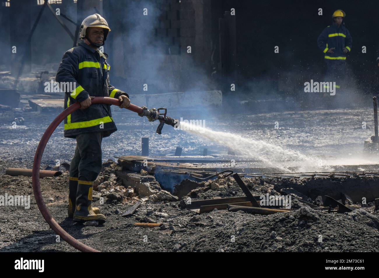 The firefighters facing a large-scale fire at the supertanker base in ...