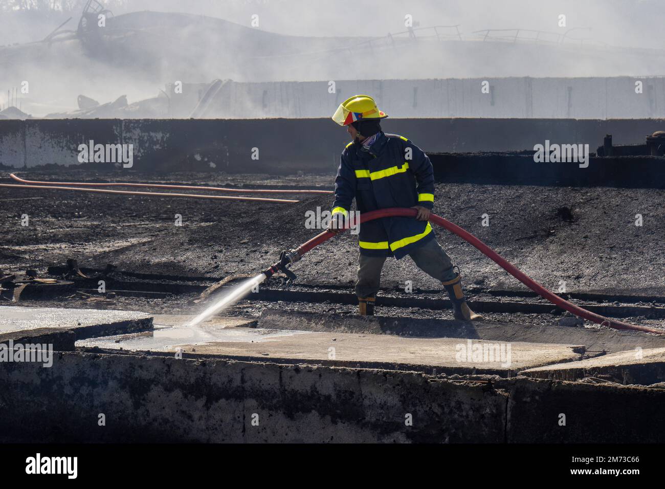 A firefighter facing a large-scale fire at the supertanker base in ...