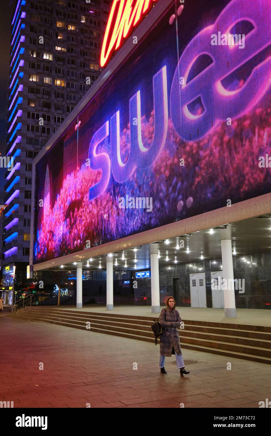 A woman walks along the sidewak on Novy Arbat (New Arbat) street at ...