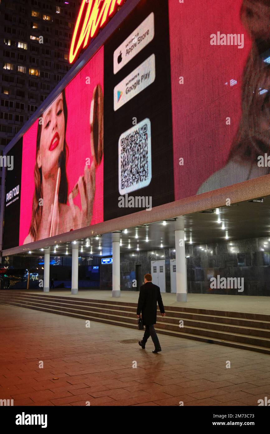 A man walks along the sidewak on Novy Arbat (New Arbat) street at night ...