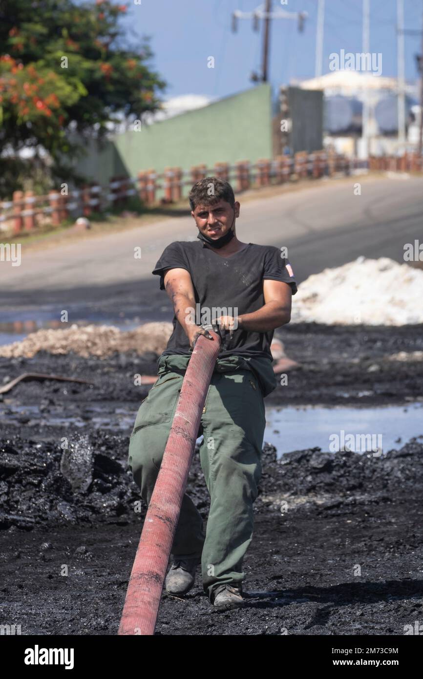 A firefighter collecting accessories after putting out a fire in ...