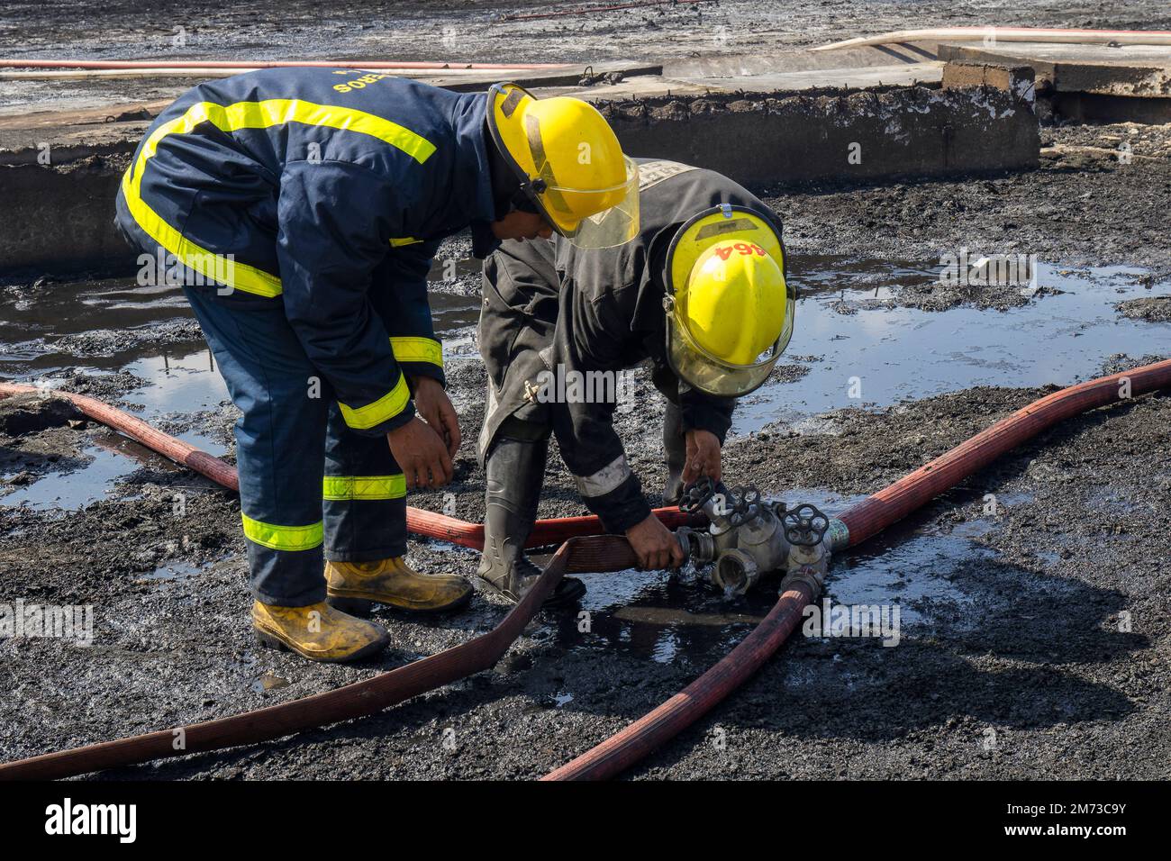 The firefighters facing a large-scale fire at the supertanker base in ...