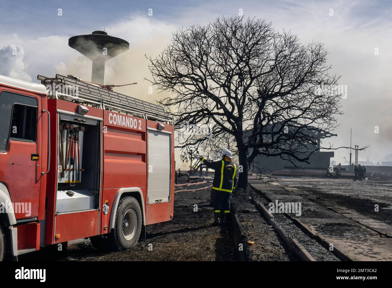 The firefighters facing a large-scale fire at the supertanker base in ...