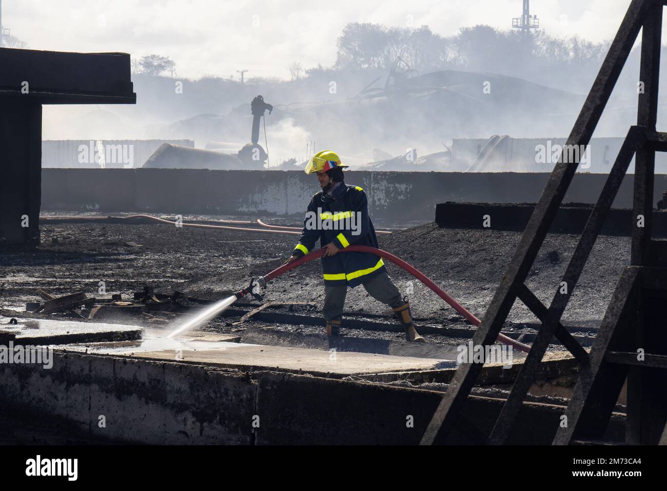 A firefighter facing a large-scale fire at the supertanker base in ...