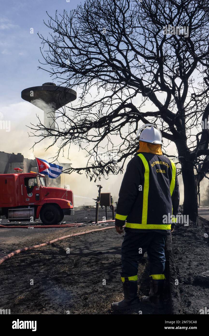 A firefighter facing a large-scale fire at the supertanker base in ...