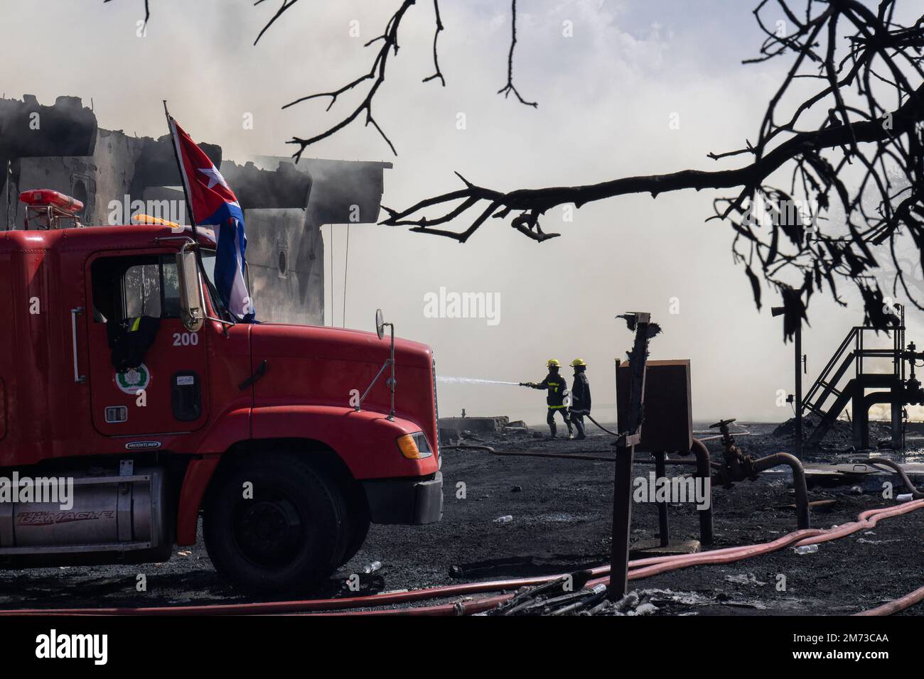 The firefighters facing a large-scale fire at the supertanker base in ...