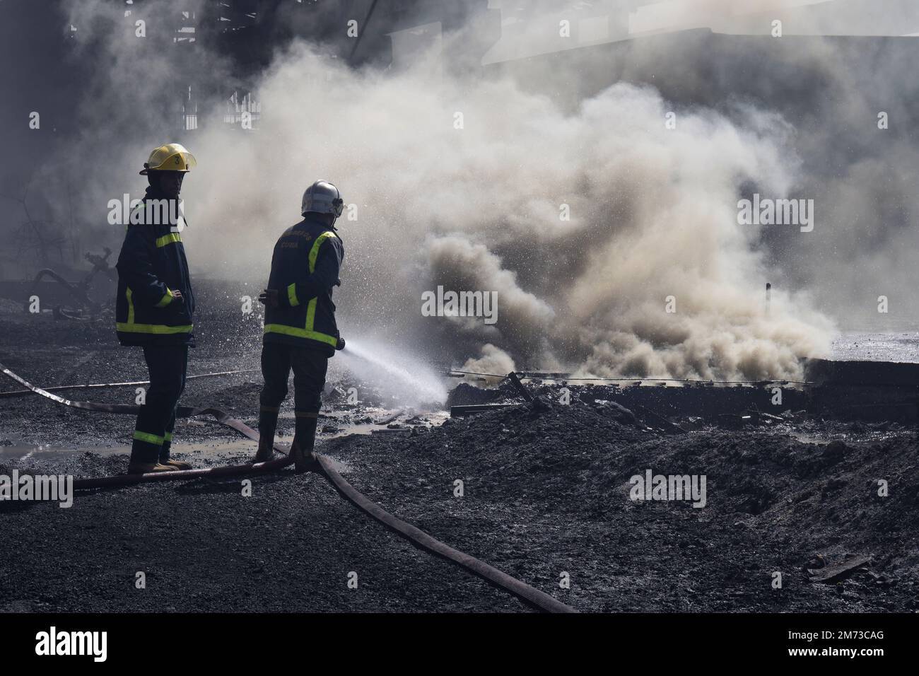 The firefighters facing a large-scale fire at the supertanker base in ...