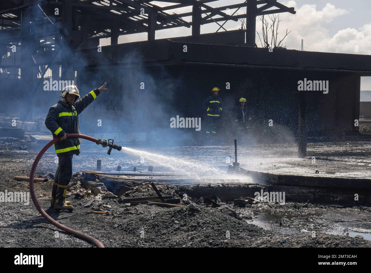 The firefighters facing a large-scale fire at the supertanker base in ...