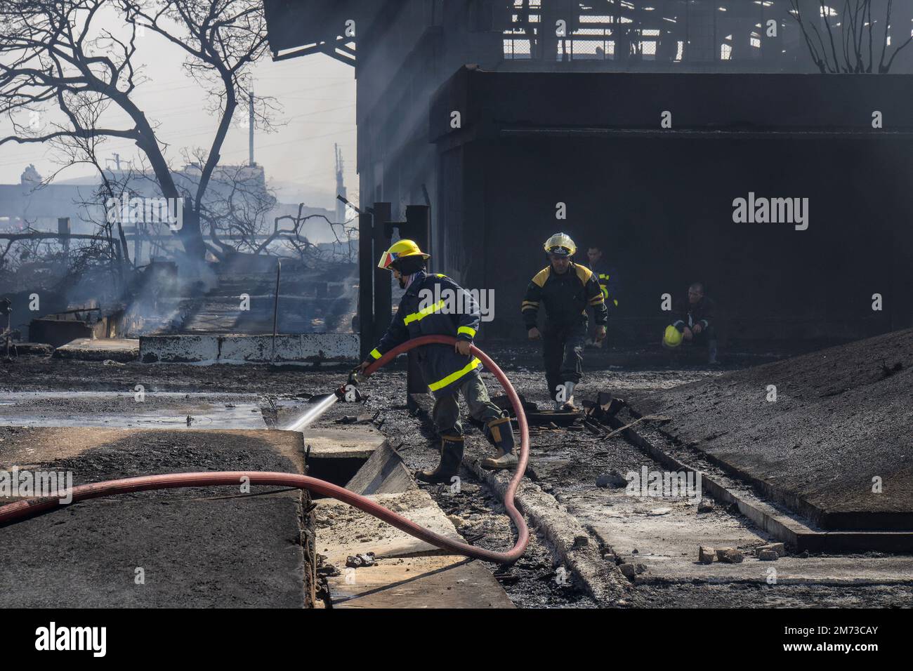 The firefighters facing a large-scale fire at the supertanker base in ...