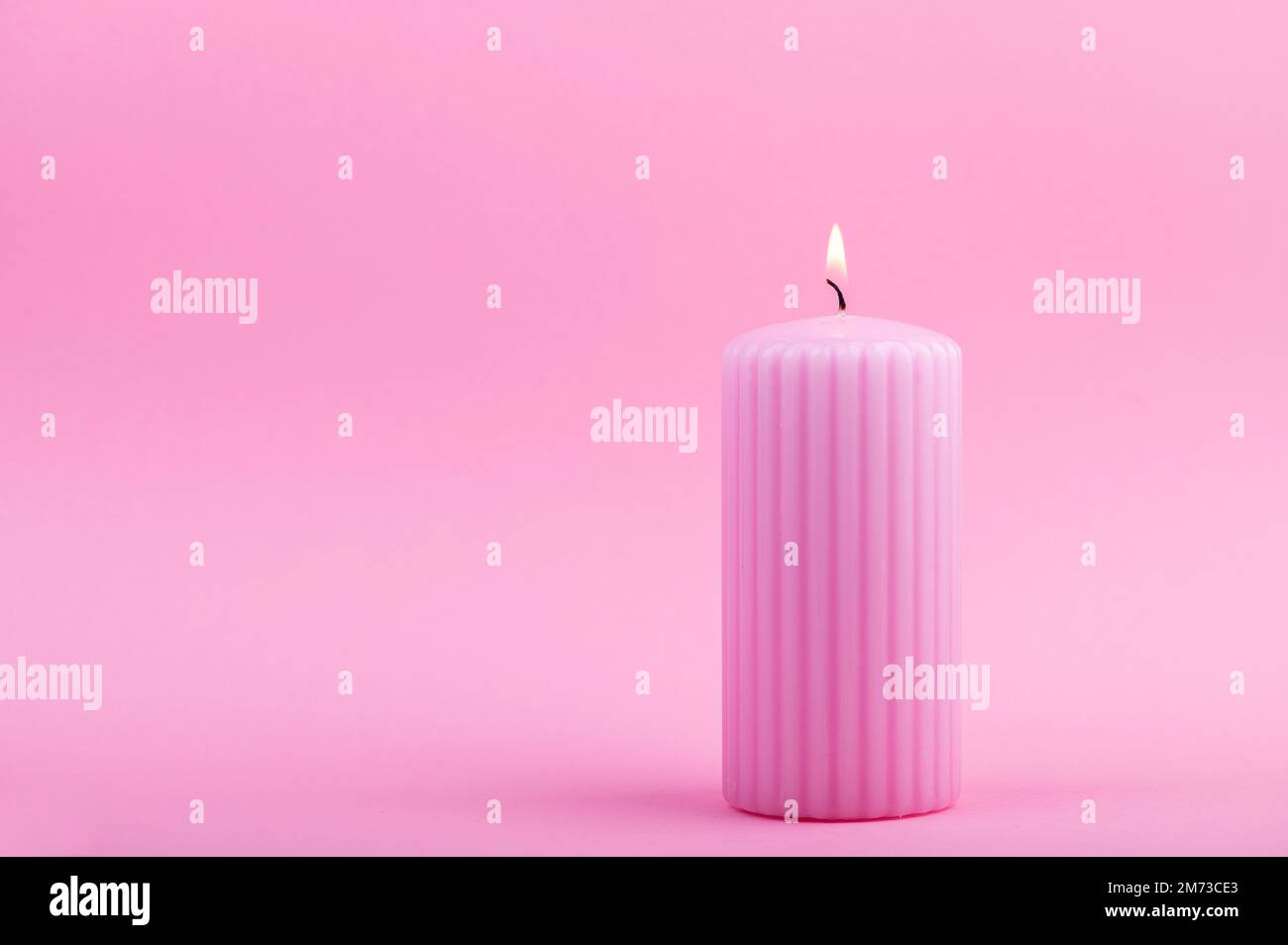 pastel colors background with pink burning candle on pink background ...