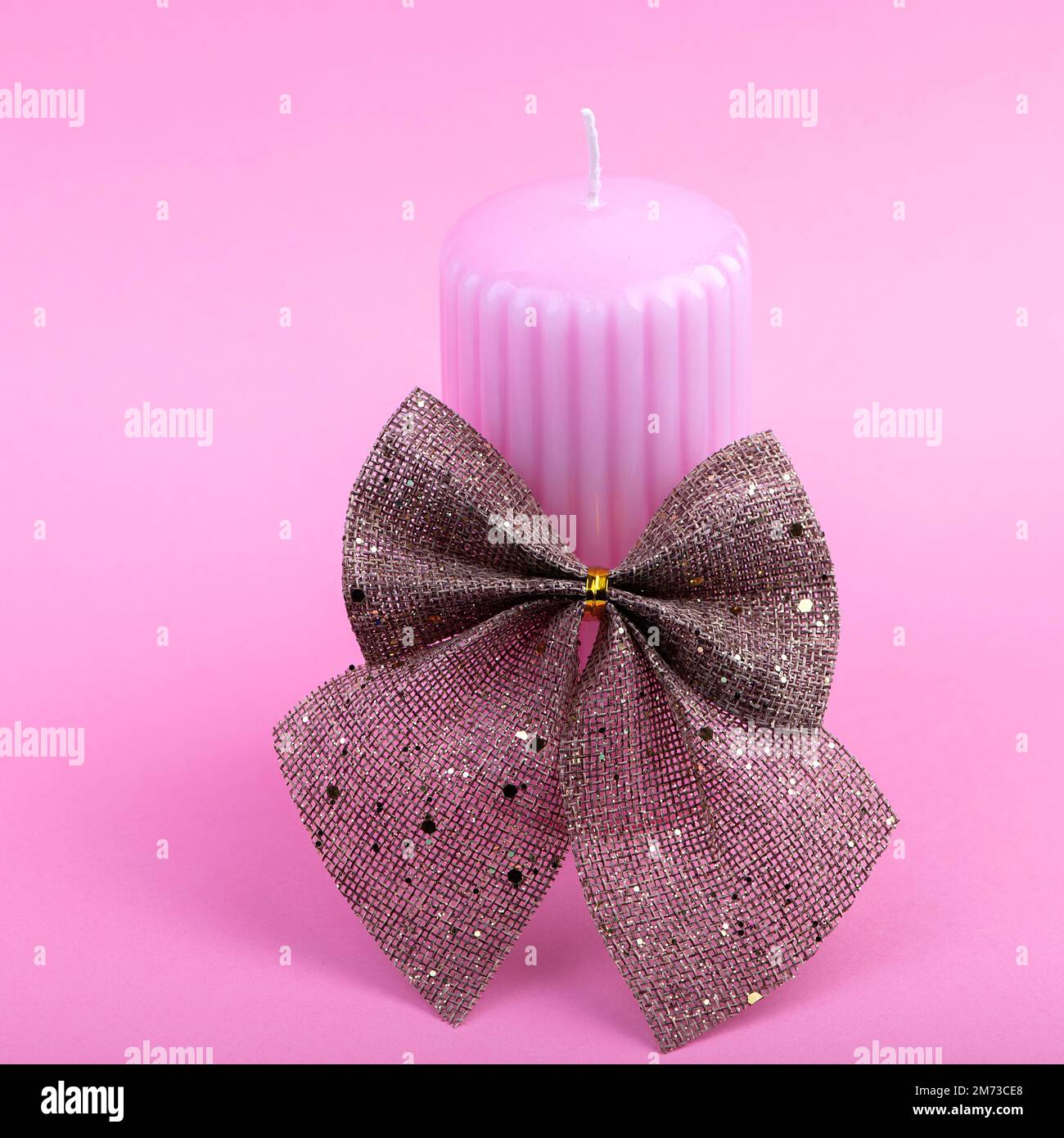 pastel colors pink candle with beautiful neutral color bow on pink ...