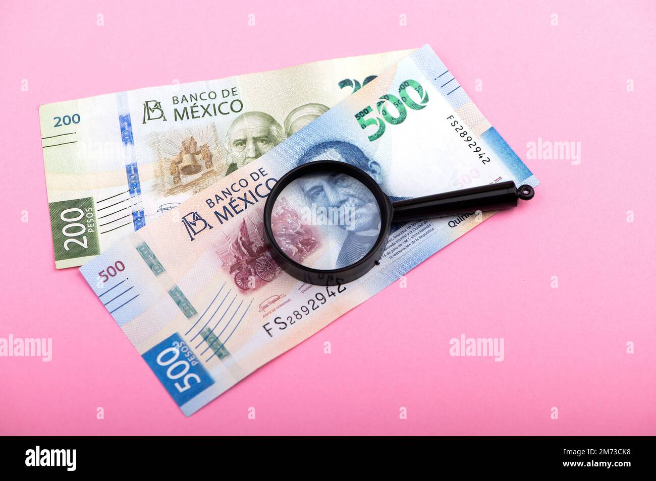 Paper currency of Mexico and magnifier on pink background, mexican ...