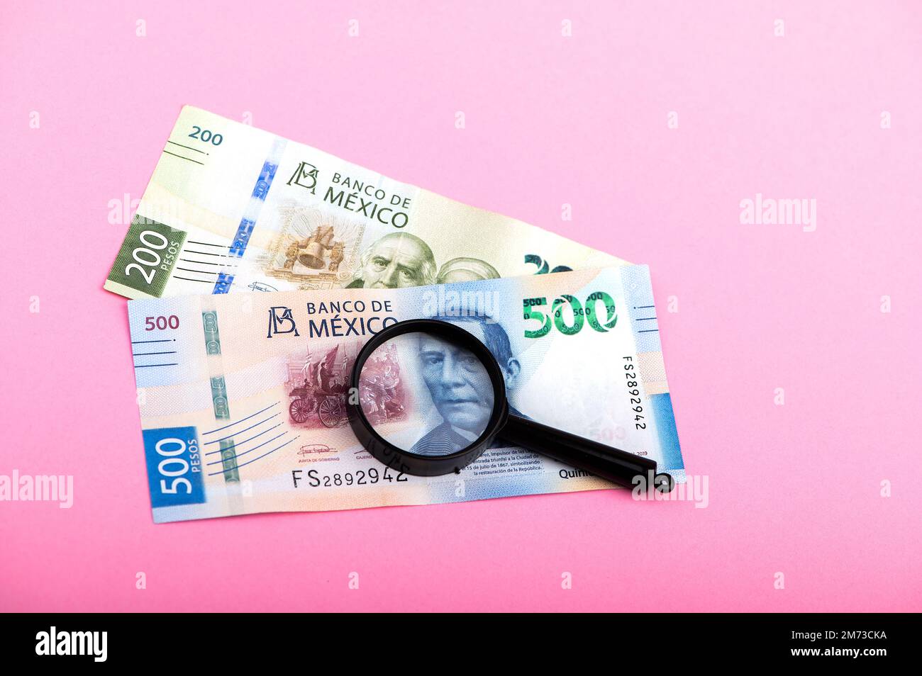 Paper currency of Mexico and magnifier on pink background, mexican ...
