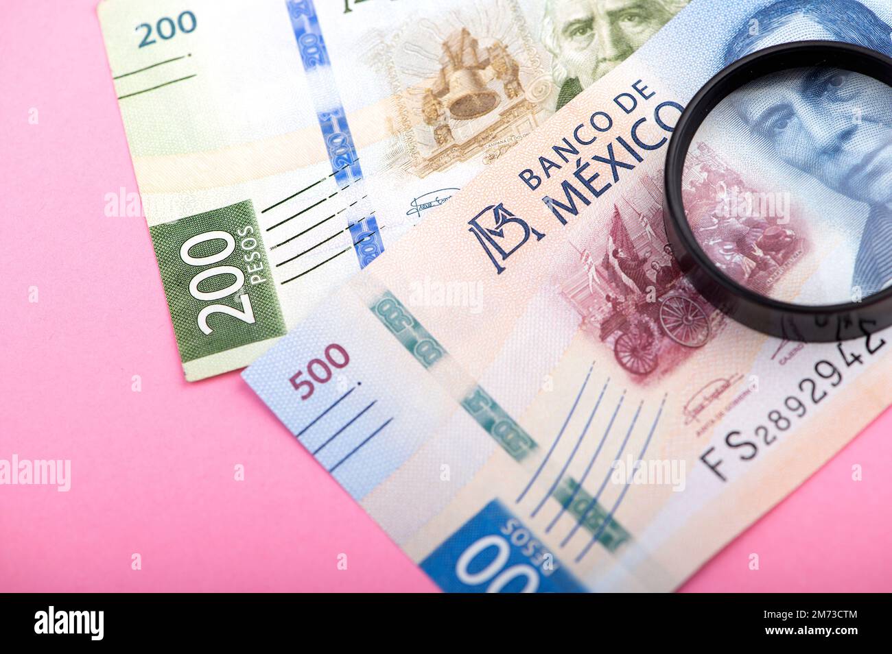 Paper currency of Mexico and magnifier on pink background, mexican ...