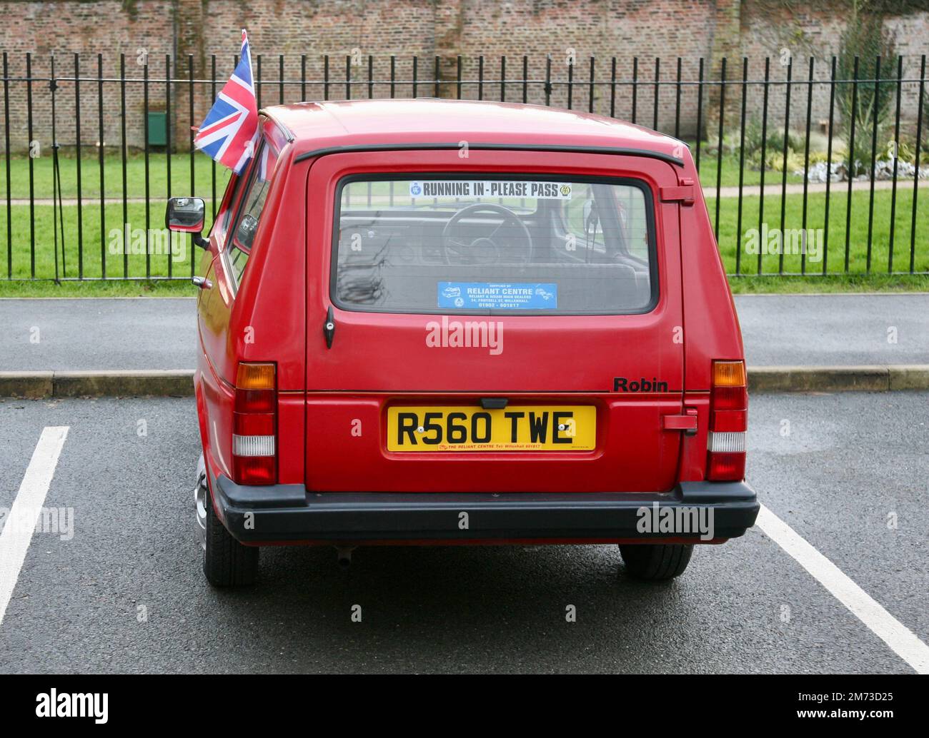 A close up view of a classic red Reliant Robin three-wheeler vehicle ...