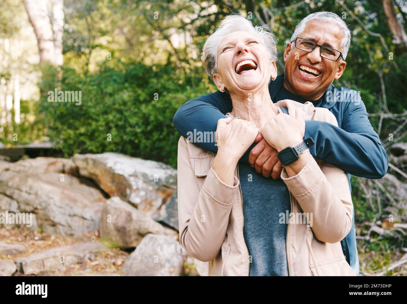 Hiking Laugh And Romance With A Senior Couple Hugging While In The