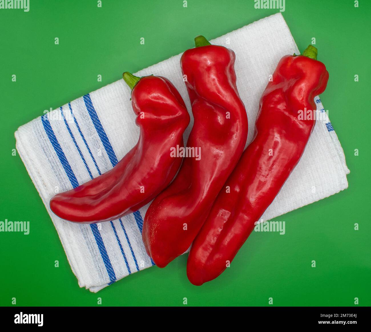 Elongated red peppers in a kitchen Stock Photo - Alamy