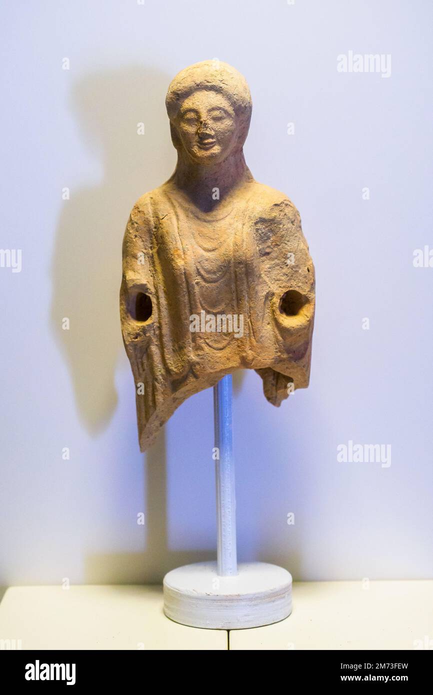 Terracotta statuette of a standing female figure wearing a Peplos ...