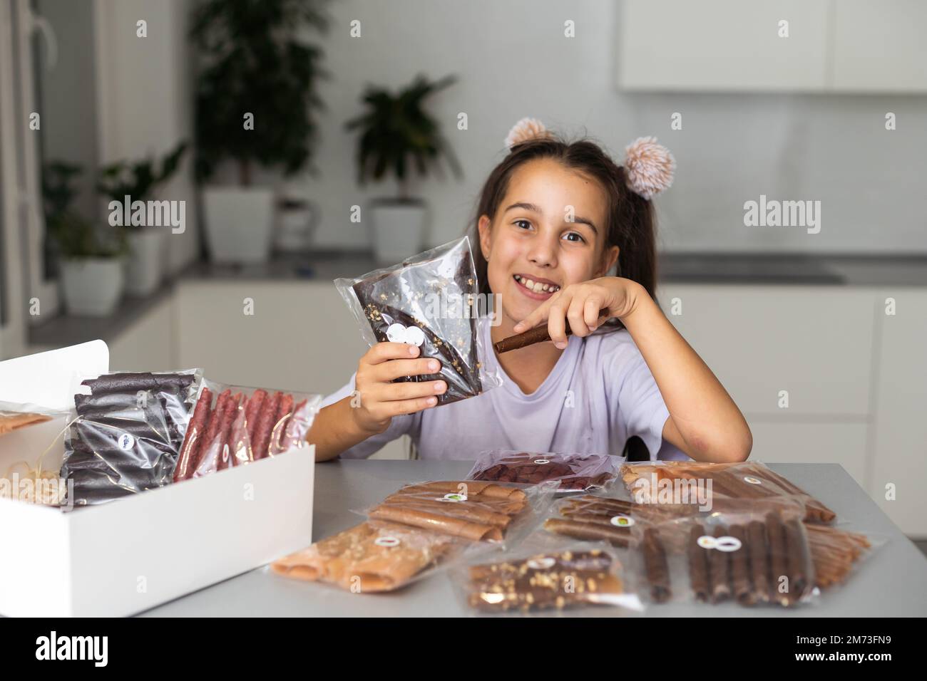Little cute girl eating berry homemade paste candy Stock Photo - Alamy