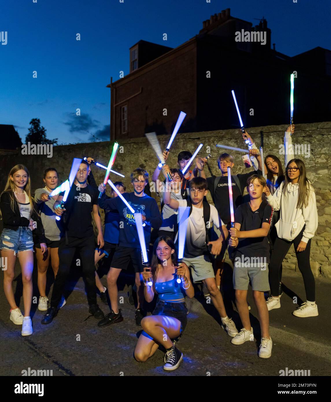 Teenagers out with electronic light sticks rerady to join procession at ...