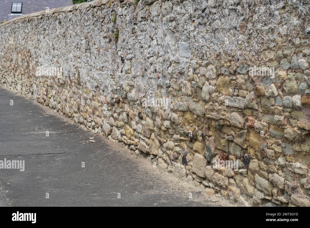 Roadside sandstone wall in southern Scotland eroded because of traffic ...
