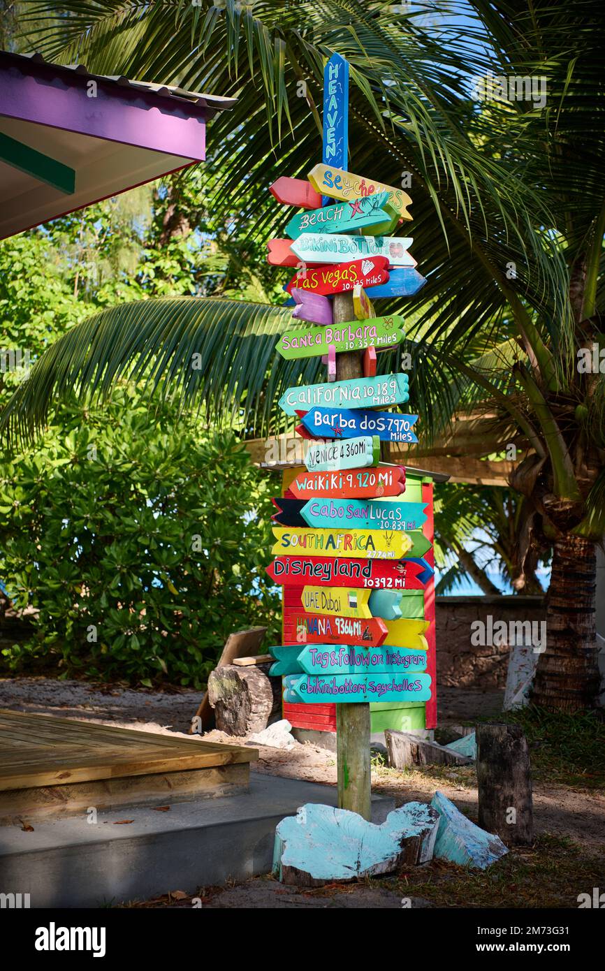 colorful information signs with distances to places around the world on ...